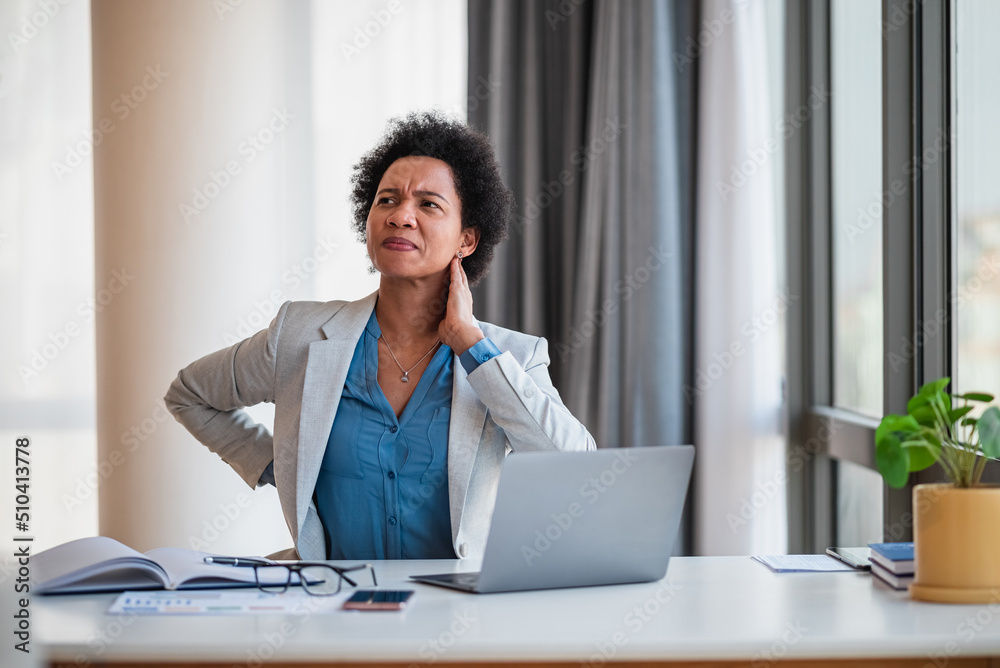 Businesswoman having neck pain and backache due to office workload ...