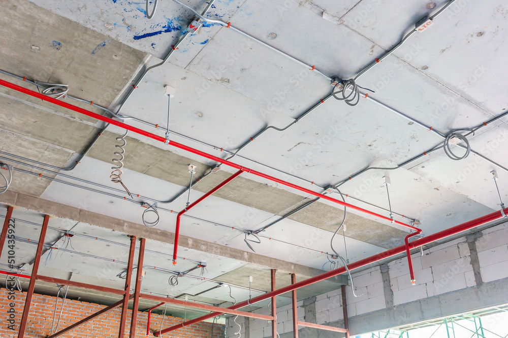 Ventilation pipes in silver insulation material and fire sprinkler on ...