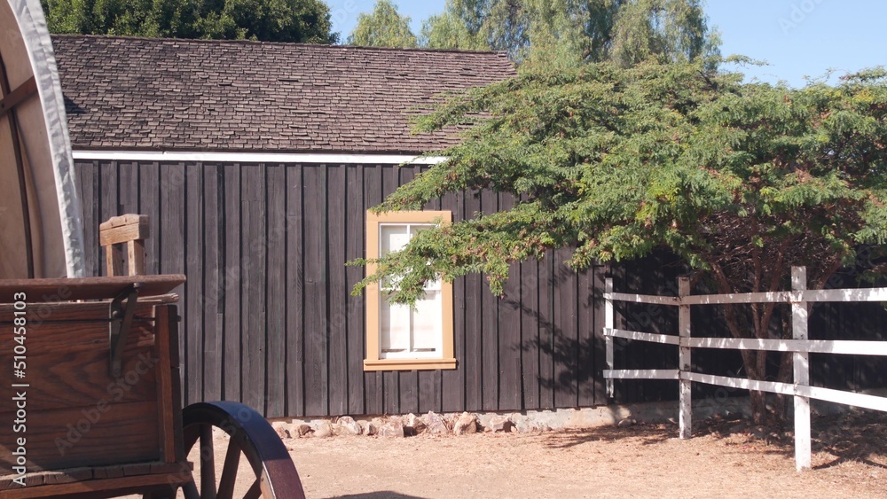 Old wooden retro covered wagon on wheels, wild west pioneer ranch. Western historic retro cart ...