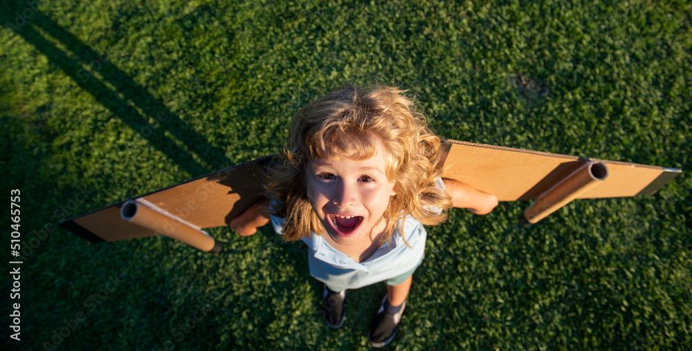 Laughing child playing with toy jetpack. Child pilot astronaut or ...