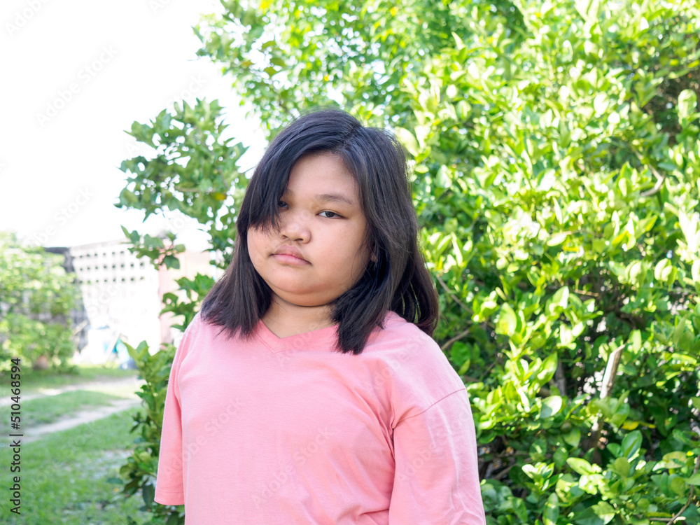 Portrait of a cute fat Asian girl, long black hair 10 years old wearing ...