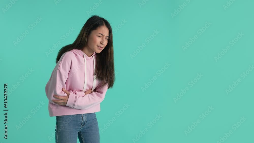 Sick asian girl clasping belly while having stocmach-ache isolated on ...
