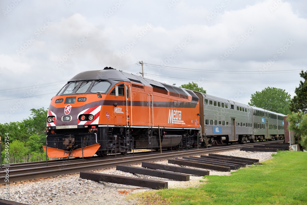 A Metra locomotive pushing a commuter train after departing the local ...