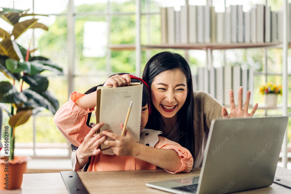 Mother and asian kid little girl learn and look at laptop computer ...