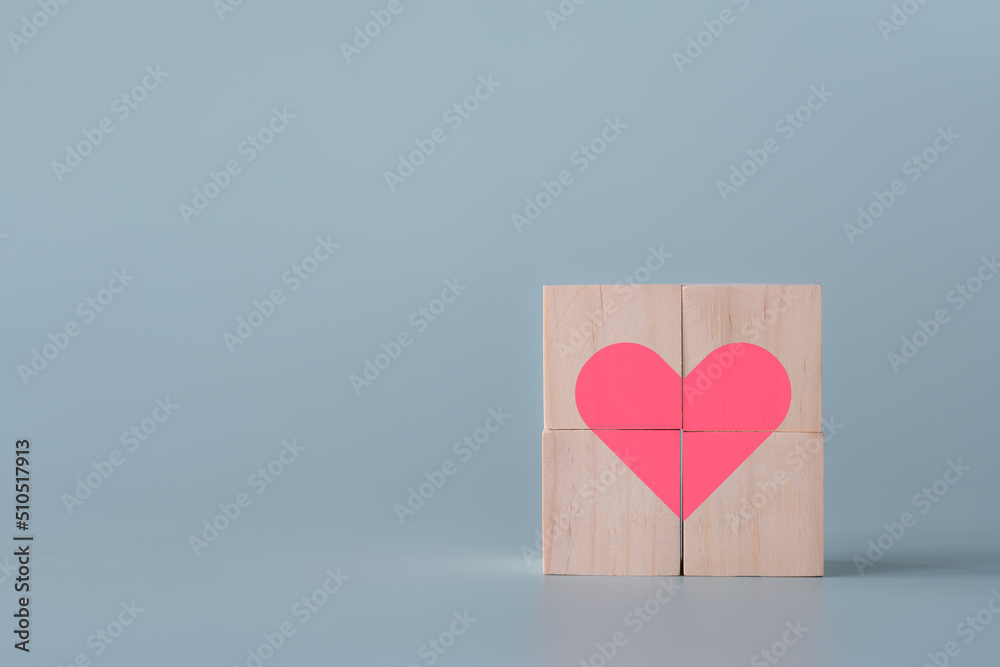 Pink heart in cube wooden blocks light blue background healthcare and ...