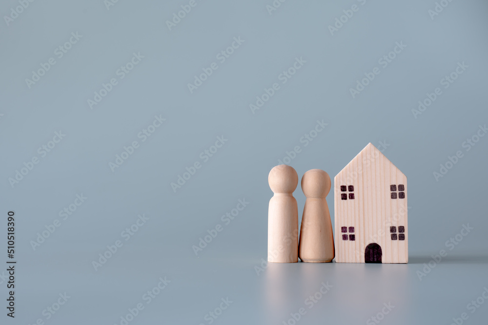 Small wooden faceless figures of human family members and house ...