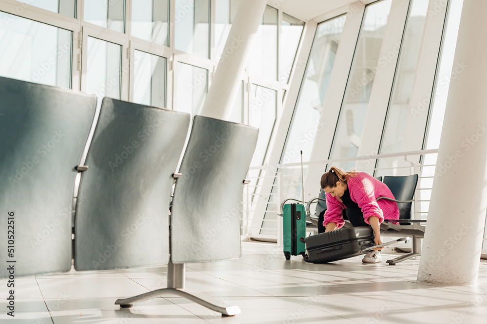 Passenger sitting on chair in modern light airport with panoramic ...