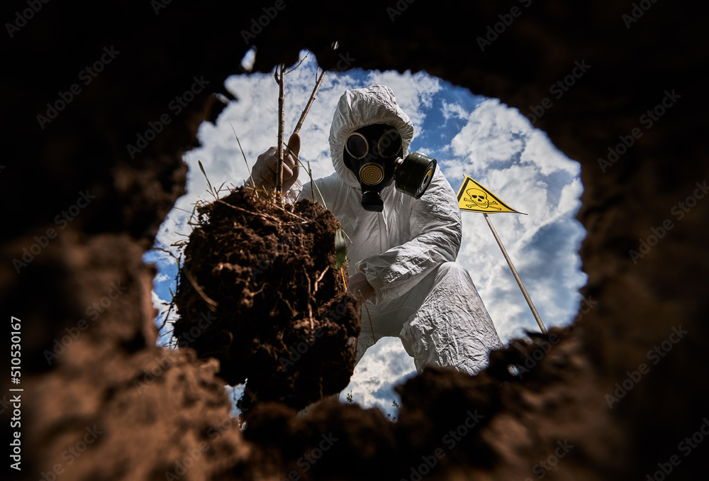 Biohazard zone. View from below, inside the pit of man in protective ...
