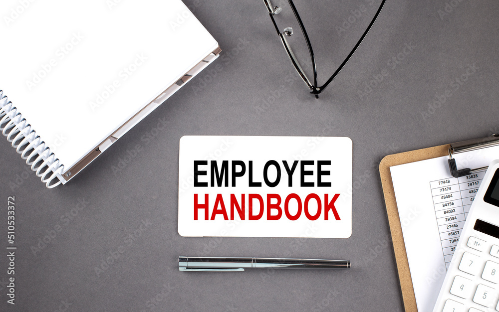 EMPLOYEE HANDBOOK Text written on the card with notebook and clipboard ...