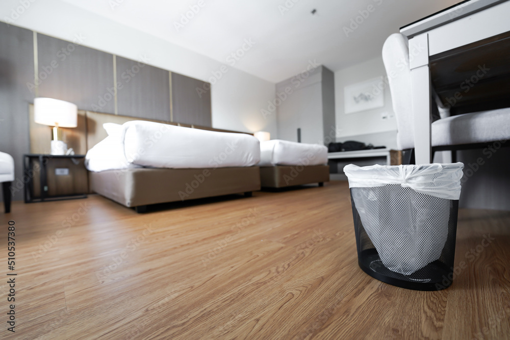 A container trash in the room with plastic inside it in hotel and ...