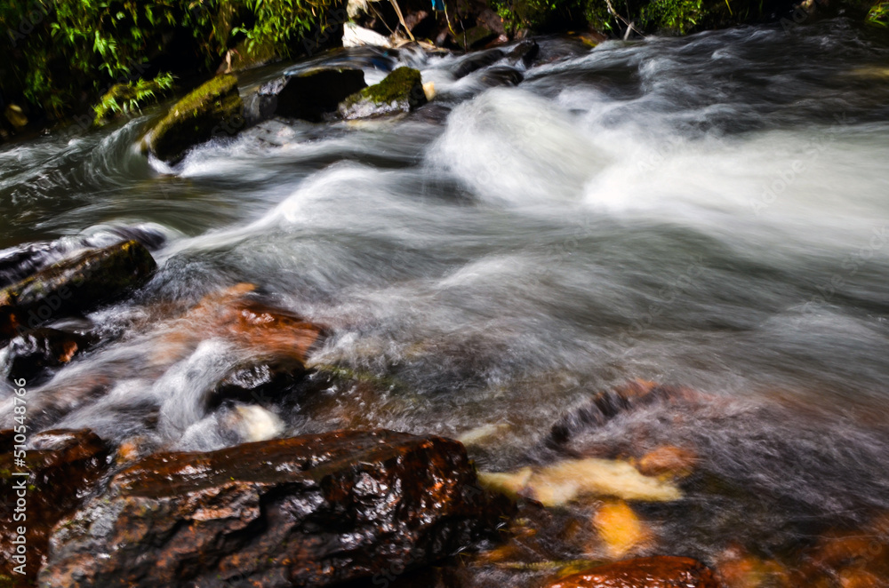 Milky water flowing from the waterfalls to the lake. Milky shots of ...