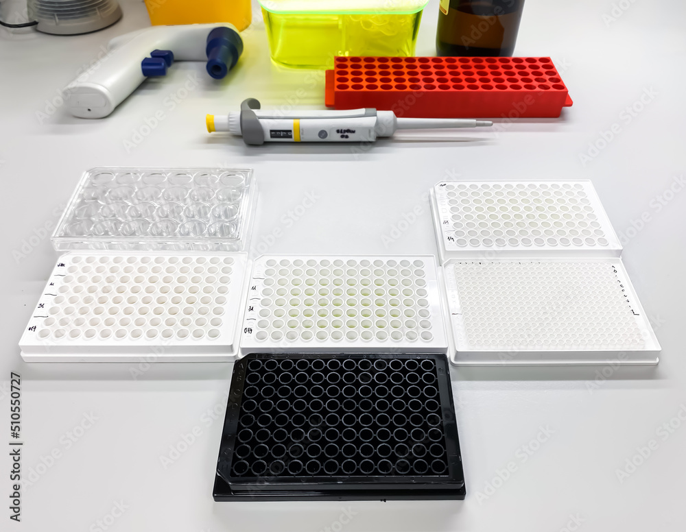 Different types of multiwell plates on the laboratory bench. Such ...