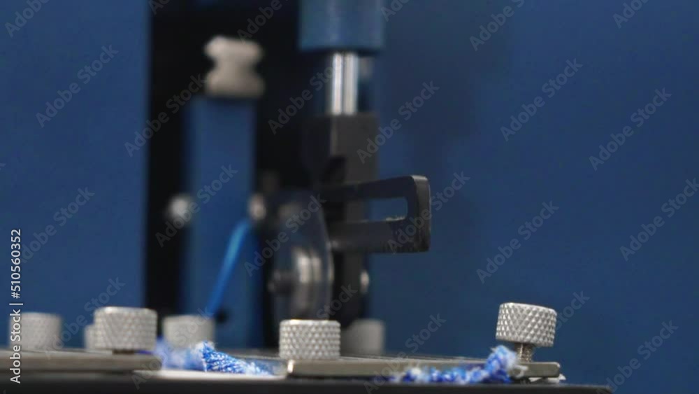 Industrial machine stress testing a piece of fabric Stock Video | Adobe ...