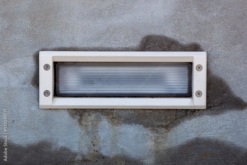 Fixed stair light embedded in concert with a white frame.. Photographer ...