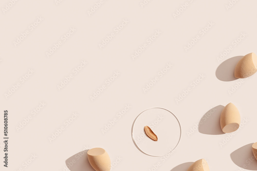 Makeup sponges for foundation cream, samples on glass disk on beige ...