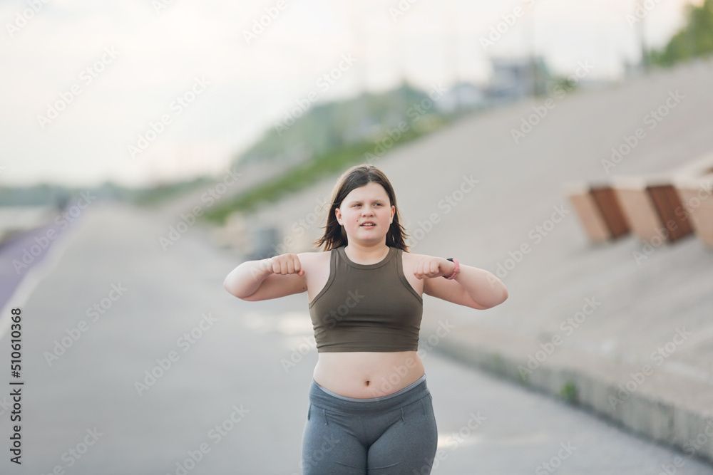 Obese fat kid girl training and exercise at park town on morning ...