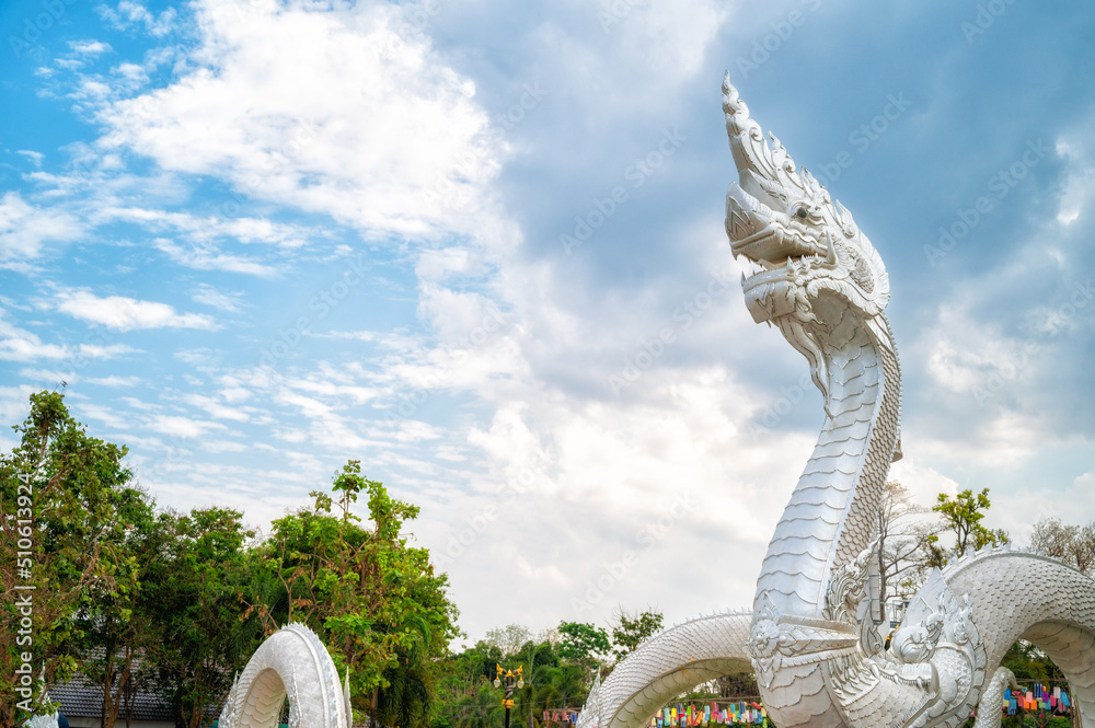 Big White Naga Statue beside Mekong river with blue sky, a tourist ...