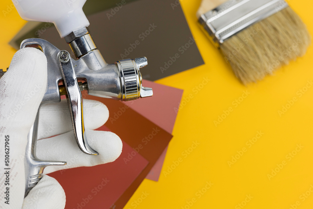paint spray gun at work at the workplace in the workshop. Stock Photo ...
