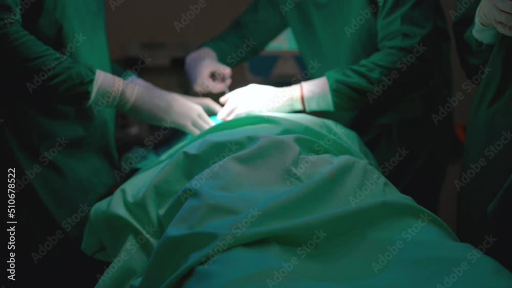 Close up operating doctor and nurse with special glasses do the process ...