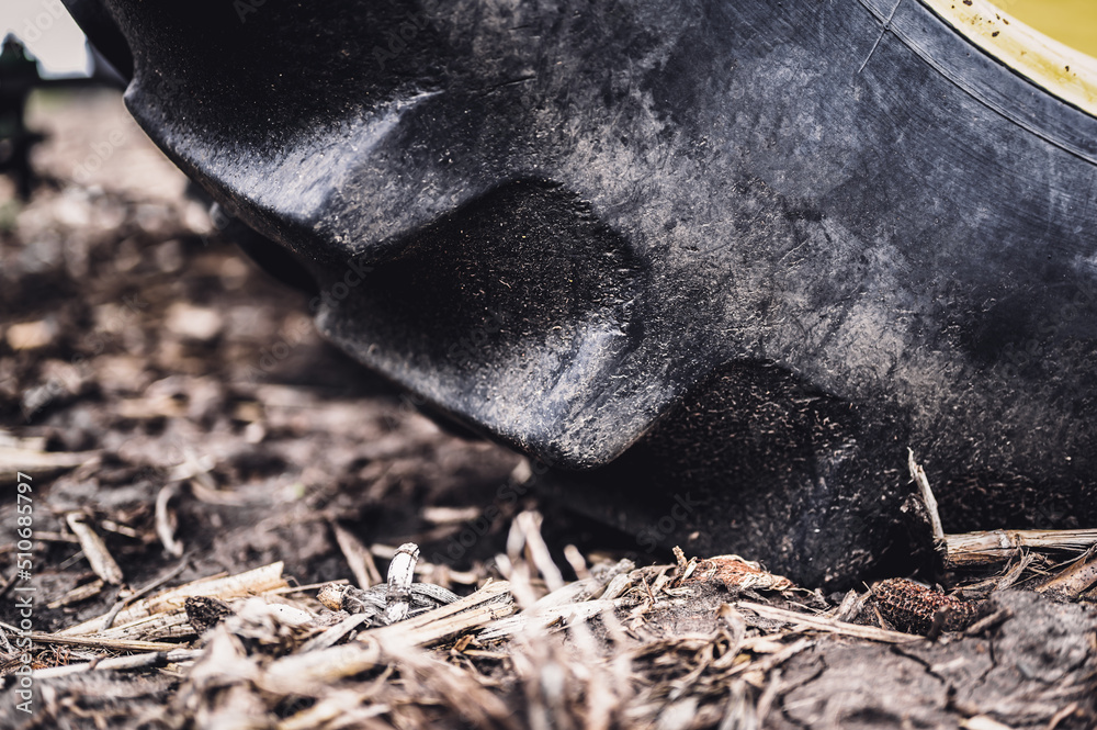 Soil compaction caused by a large tractor tire over topsoil dirt in an ...