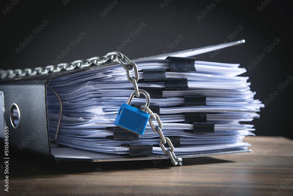 Documents locked with padlock and chains. Stock Photo | Adobe Stock