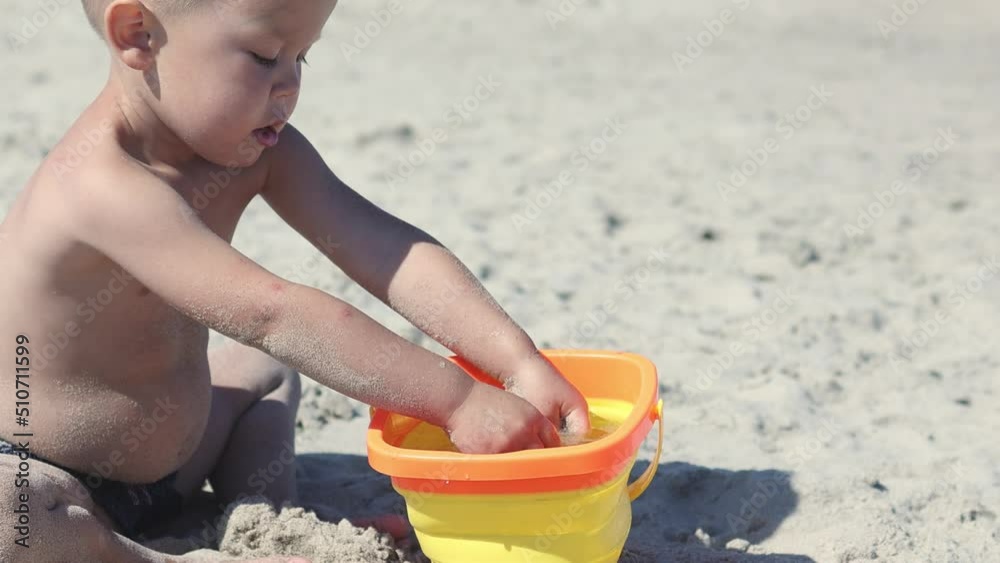 little baby boy child running towards sea ocean sand, playing on beach ...