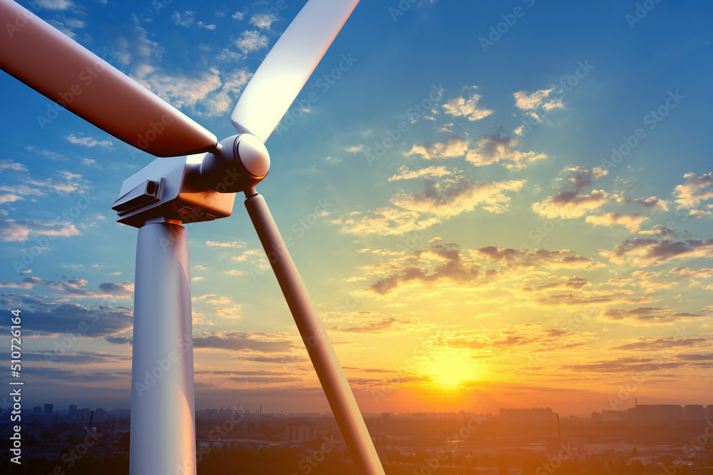 Wind turbine in front of cityscape. Installation for generating ...