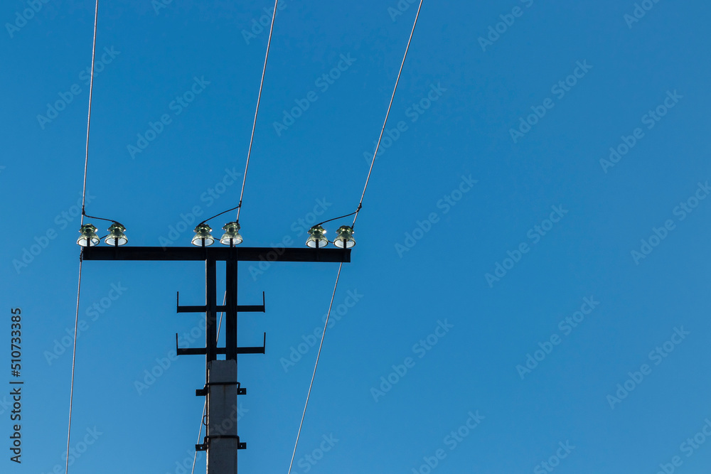 Upper part of a three-phase transmission line tower with insulators ...