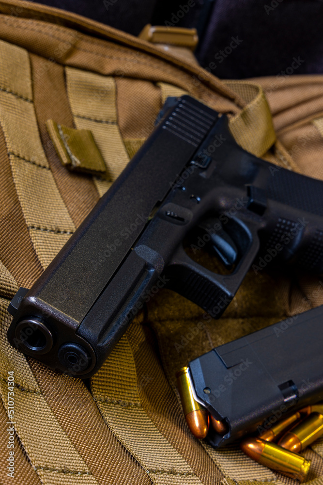 Artistic photo of a semi automatic 9mm handgun on a brown background in ...