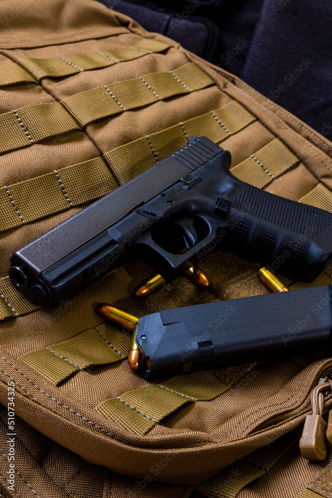 Artistic photo of a semi automatic 9mm handgun on a brown background in ...