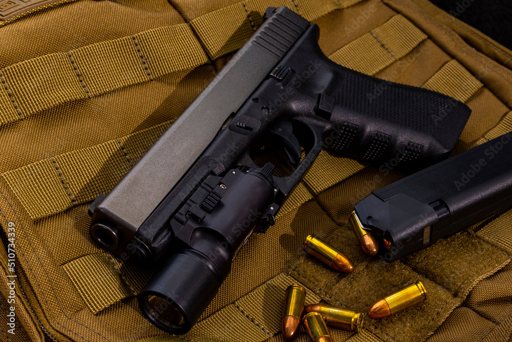 Artistic photo of a semi automatic 9mm handgun with a tactical flash ...
