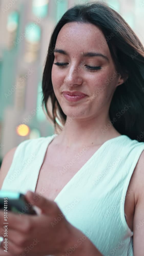 VERTICAL VIDEO: Beautiful smiling woman with freckles and dark loose ...