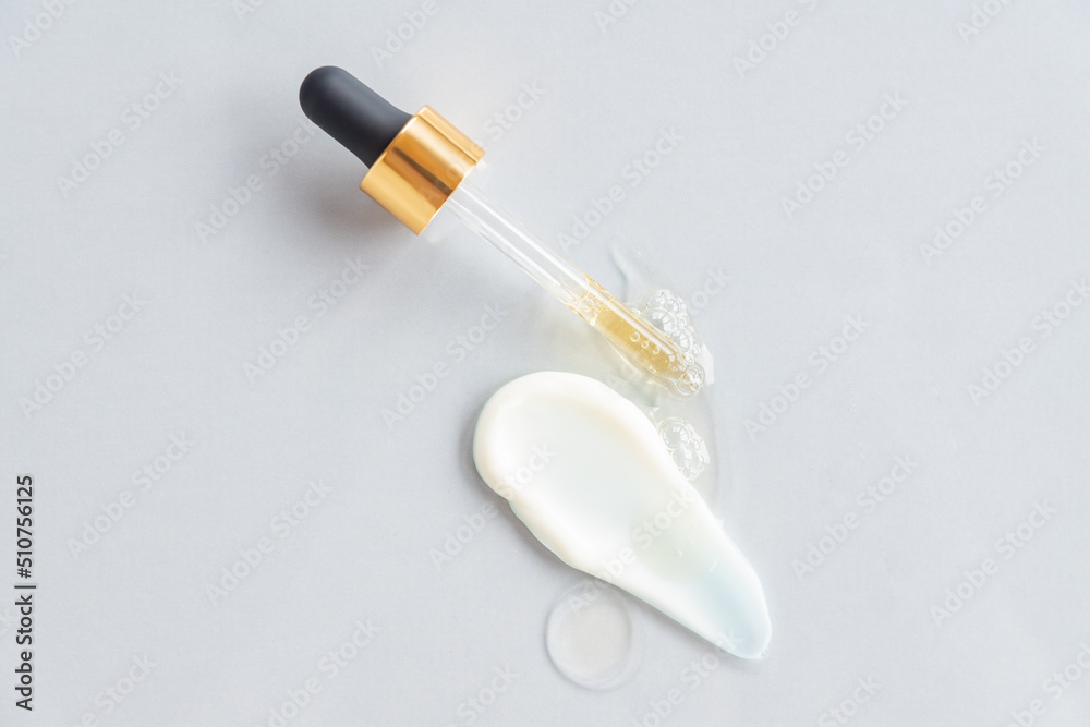 Pipette and drops and smears of cosmetics. Liquid gel or a drop of ...