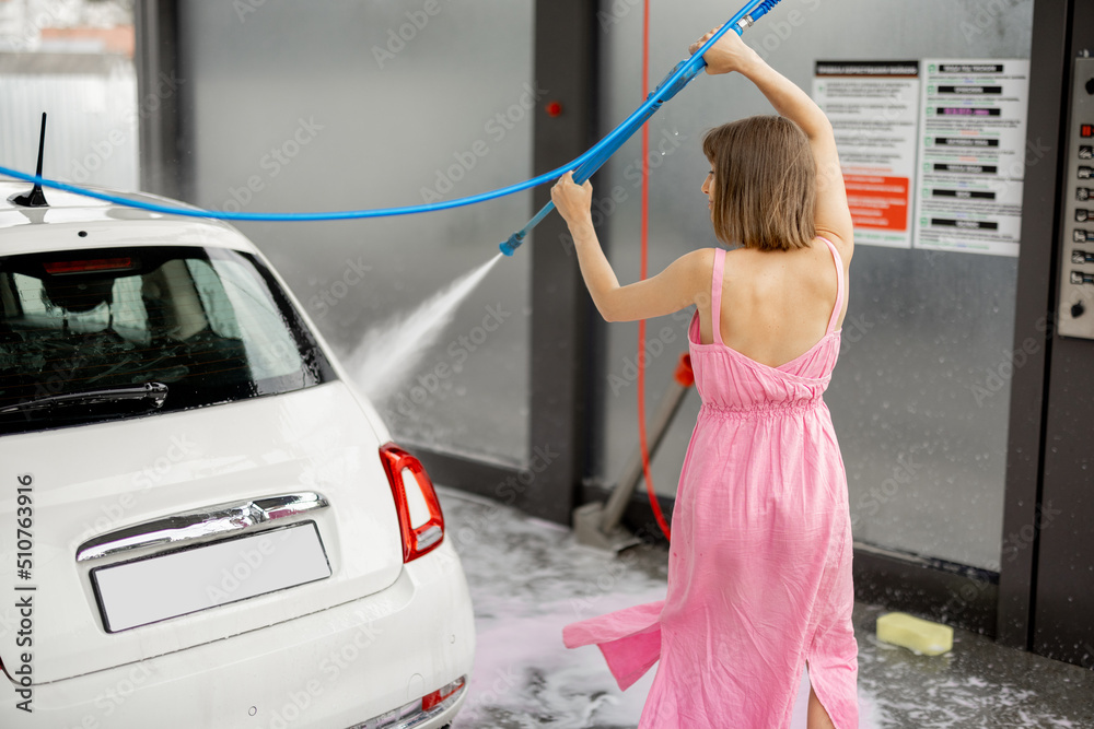 Cute woman washes her vehicle at self-service car wash Stock Photo ...