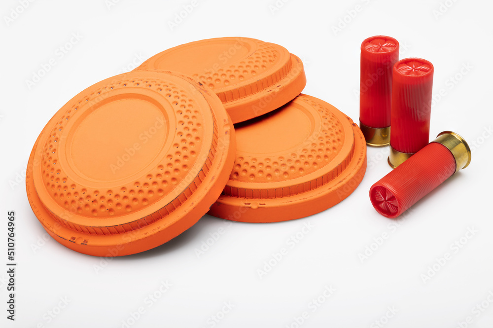 Red shotgun shell and clay pigeon target on white background , Gun ...