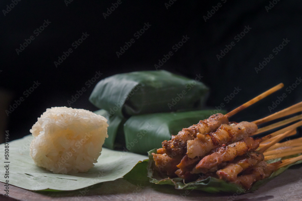 front view of grilled skewered pork(Moo Ping) with white sticky rice ...