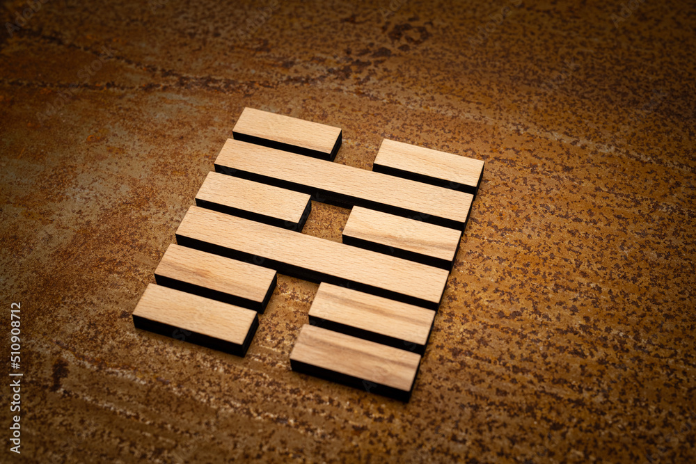 wooden Gene Key 39 i ging hexagram on rusty metal background human ...