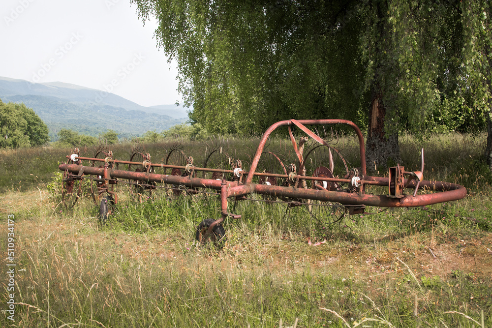 A tedder, hay tedder, used for haymaking. An old hay machine, also ...