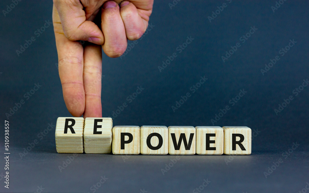 Power or repower symbol. Businessman turns wooden cubes and changes ...