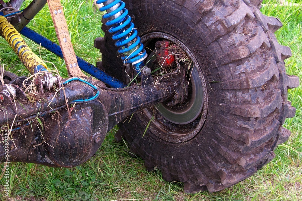 Extreme buggy ride on a dirt track. Rear suspension UTV close-up ...