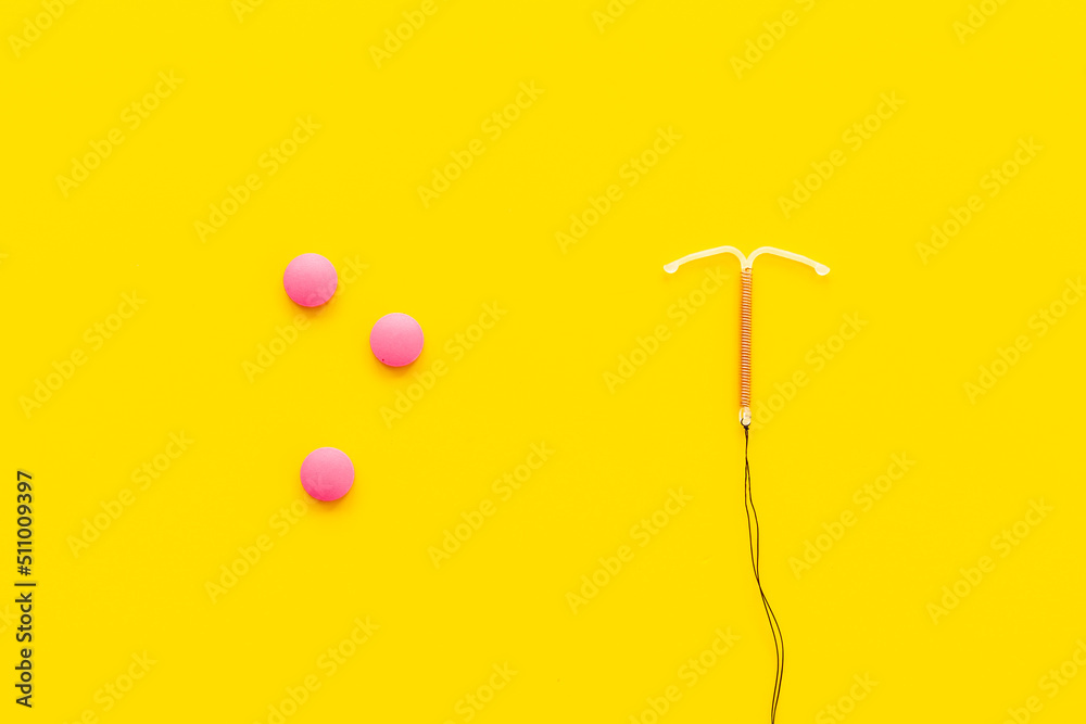Contraception concept. T-shaped intrauterine contraceptive with ...