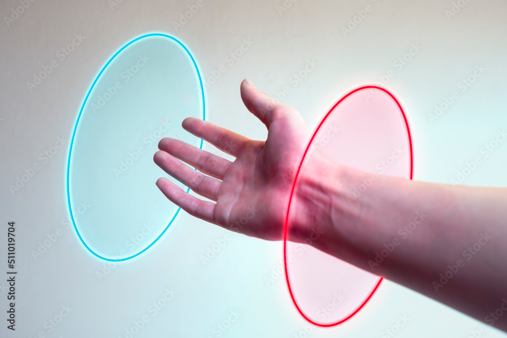 Hand entering in a neon light as a gate for new dimensions. Concept of ...