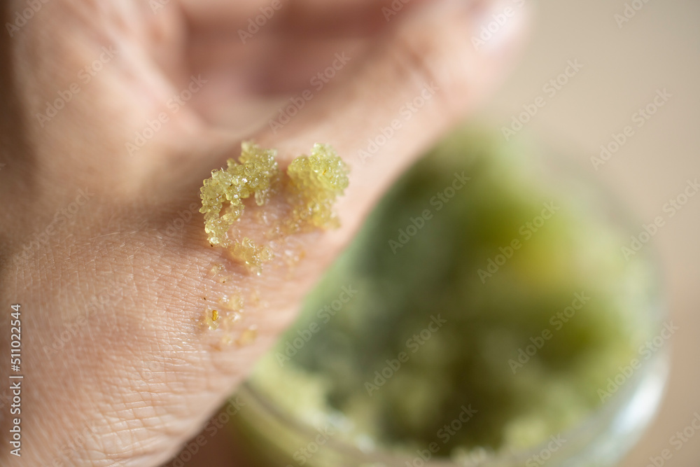 testing scrub green, on the skin of the hand. Jar with green scrub ...