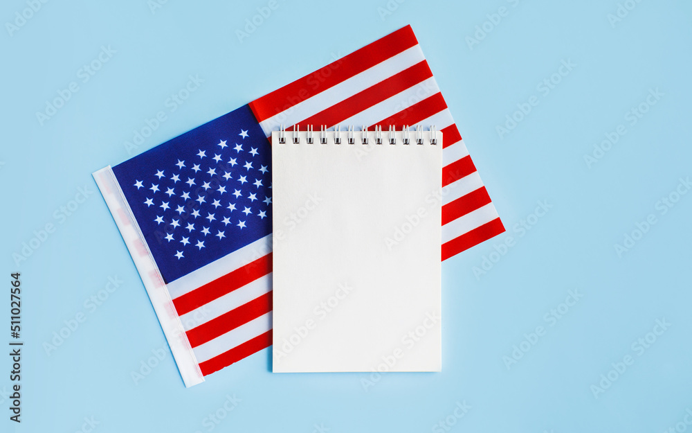 American flag with open notebook or list on blue background. United ...