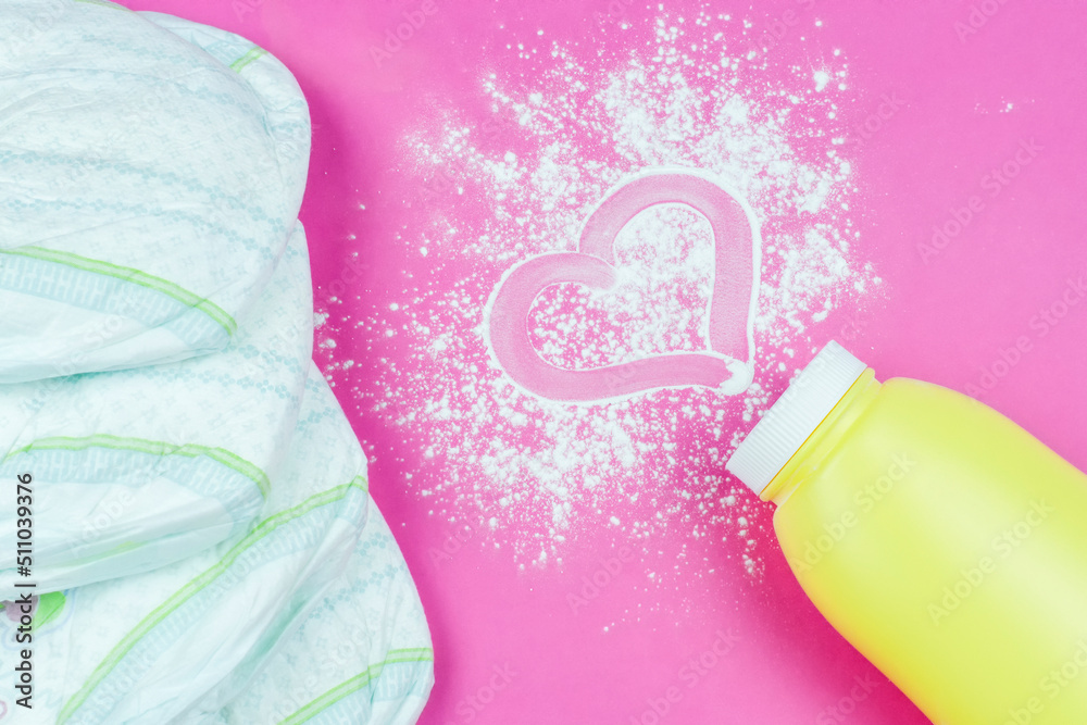 Scattered baby powder in a yellow bottle with a heart pattern on the ...