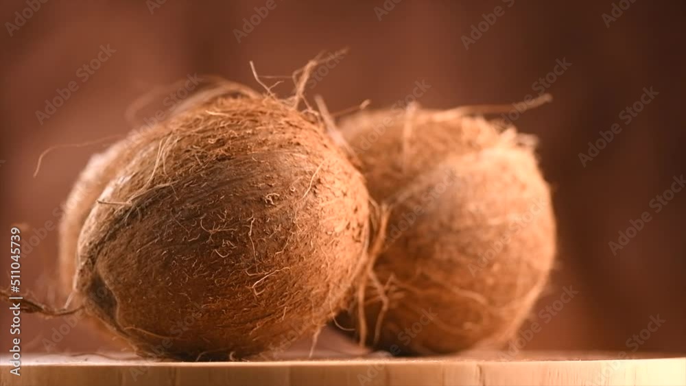 Coconut. Whole coco nut rotating on brown background. Fresh healthy ...