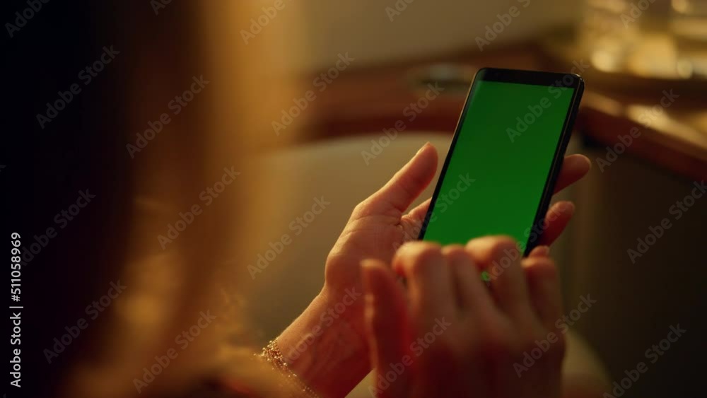 Closeup hand touching green screen device. Woman scrolling chroma key ...