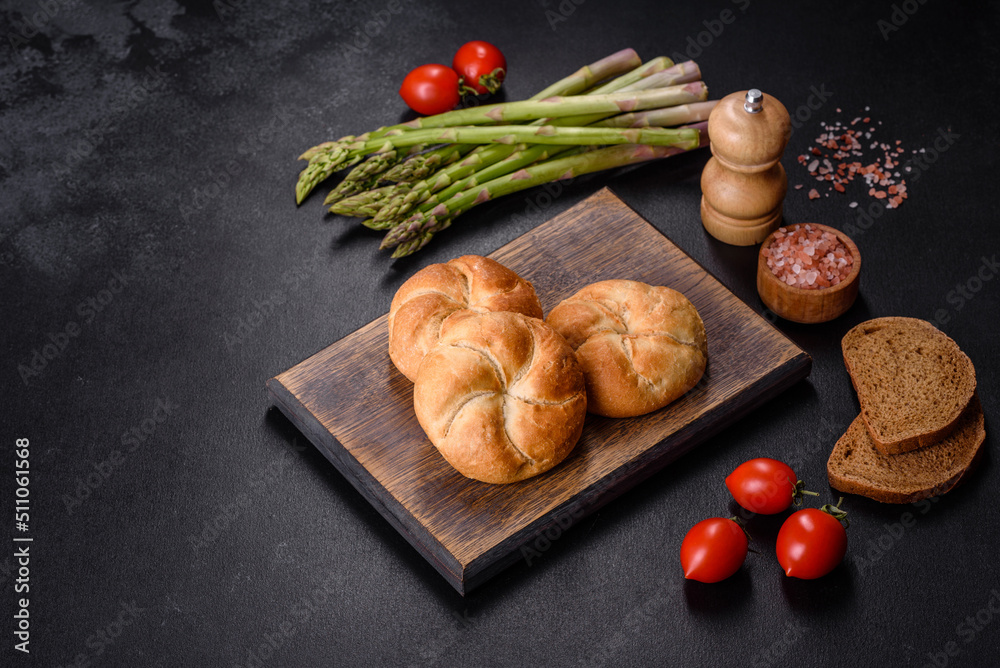 Crusty round bread rolls, known as Kaiser or Vienna rolls on a cutting ...