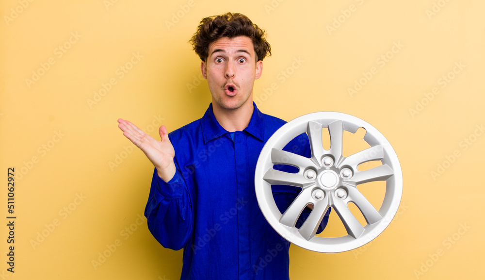 young handsome teenager looking surprised and shocked, with jaw dropped ...