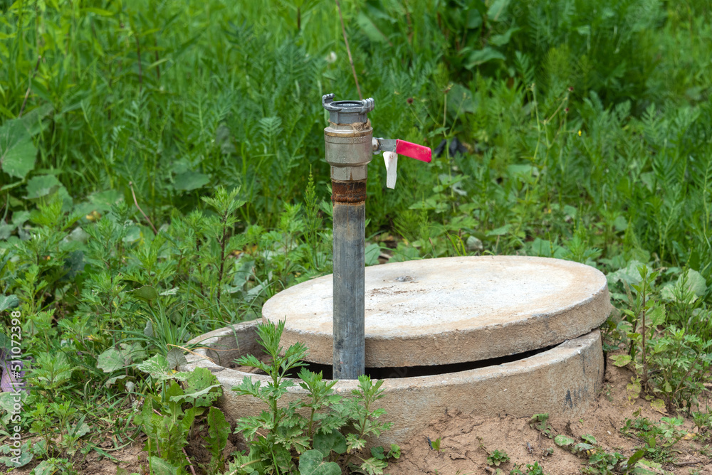 Foto de Technical concrete well with a pipe and a lever for water ...